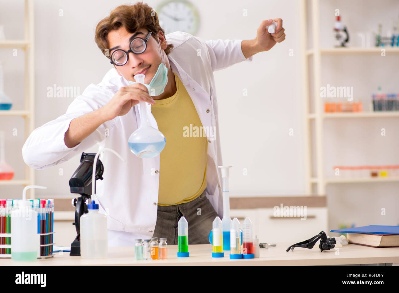 Funny crazy chemist doing experiments and tests Stock Photo - Alamy