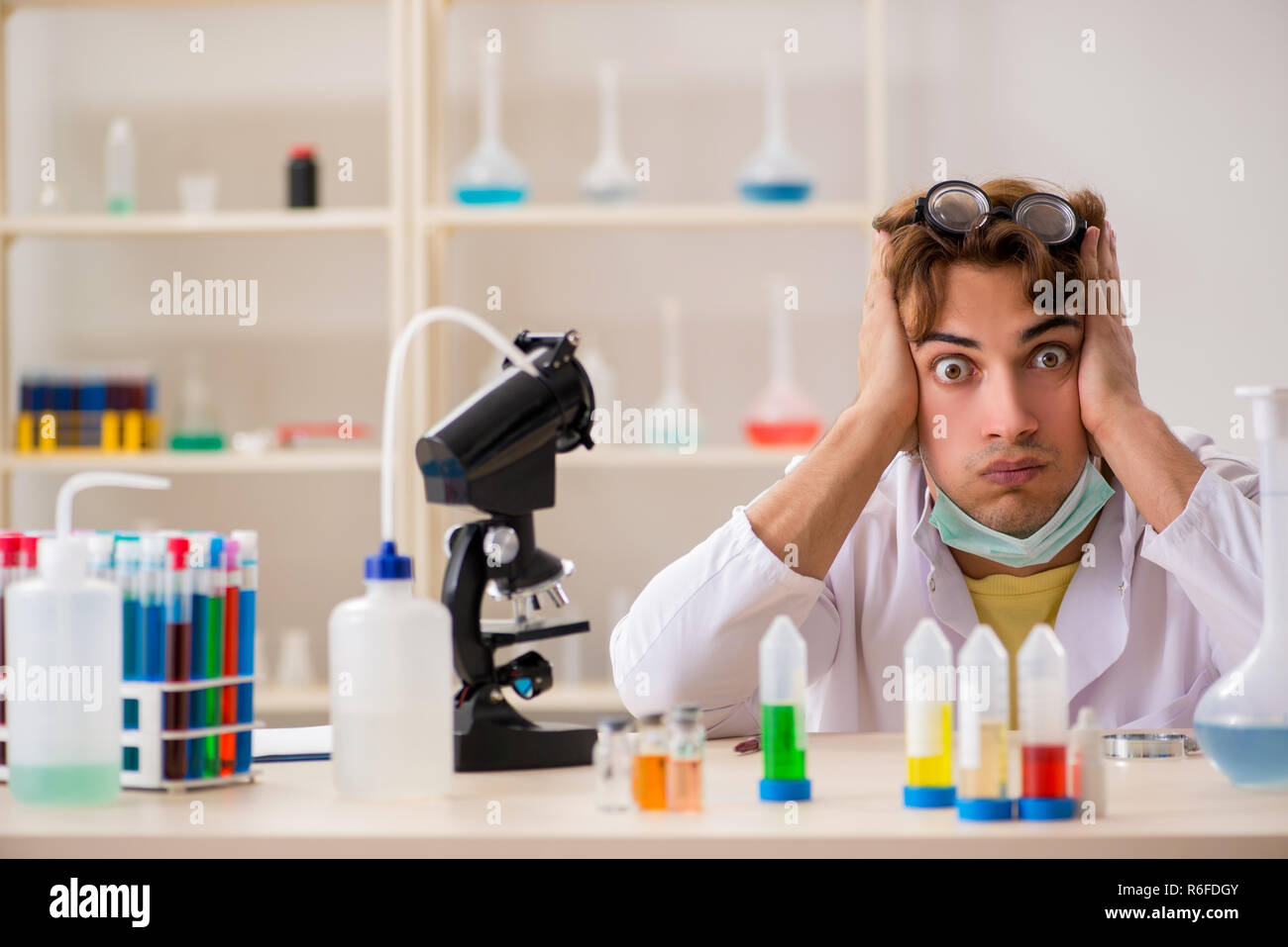 Funny crazy chemist doing experiments and tests Stock Photo - Alamy