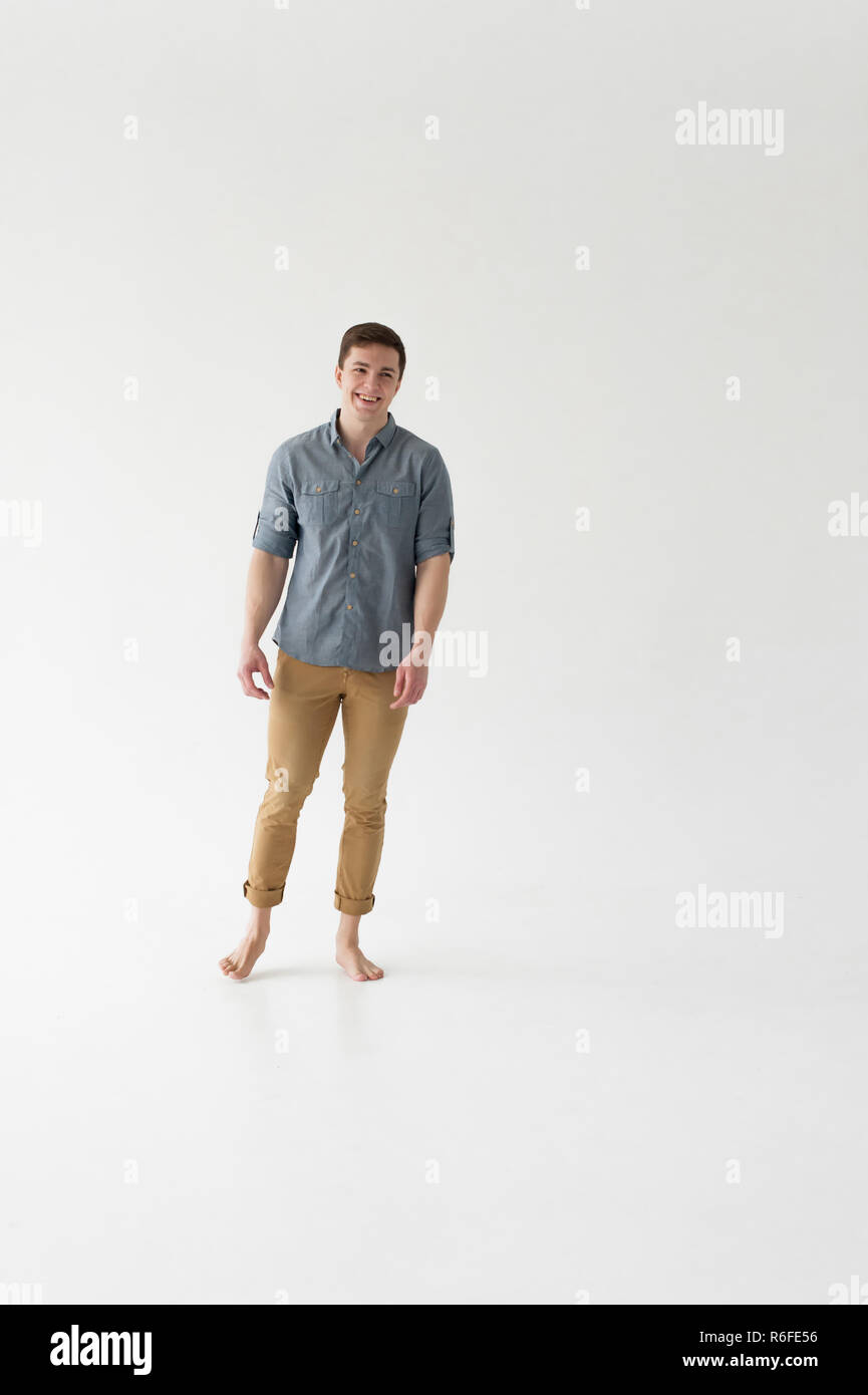 Young handsome man of strong athletic build, dressed in a shirt and ...