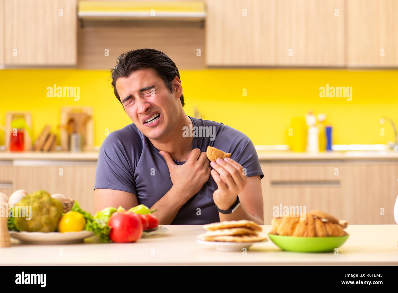 Man having hard choice between healthy and unhealthy food Stock Photo ...