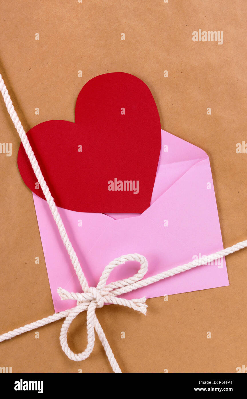 Valentines day red heart shape card or gift tag, brown paper package ...