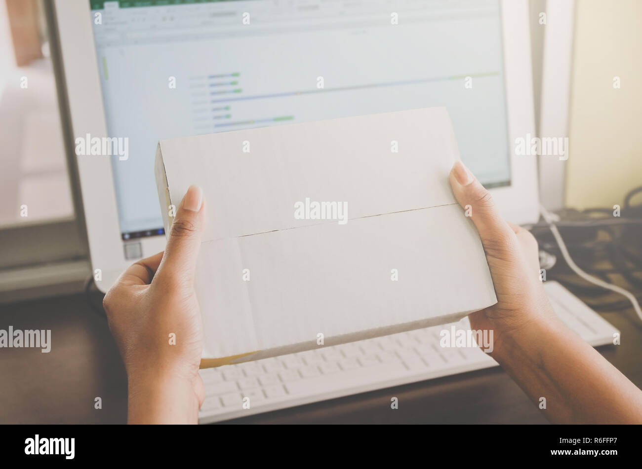 Close-up of parcel box and hand holding a package, Delivery concept and ...