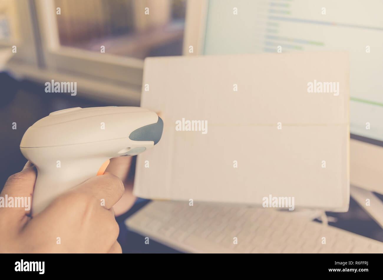 A parcel box and hand holding a package with barcode reader, Delivery ...