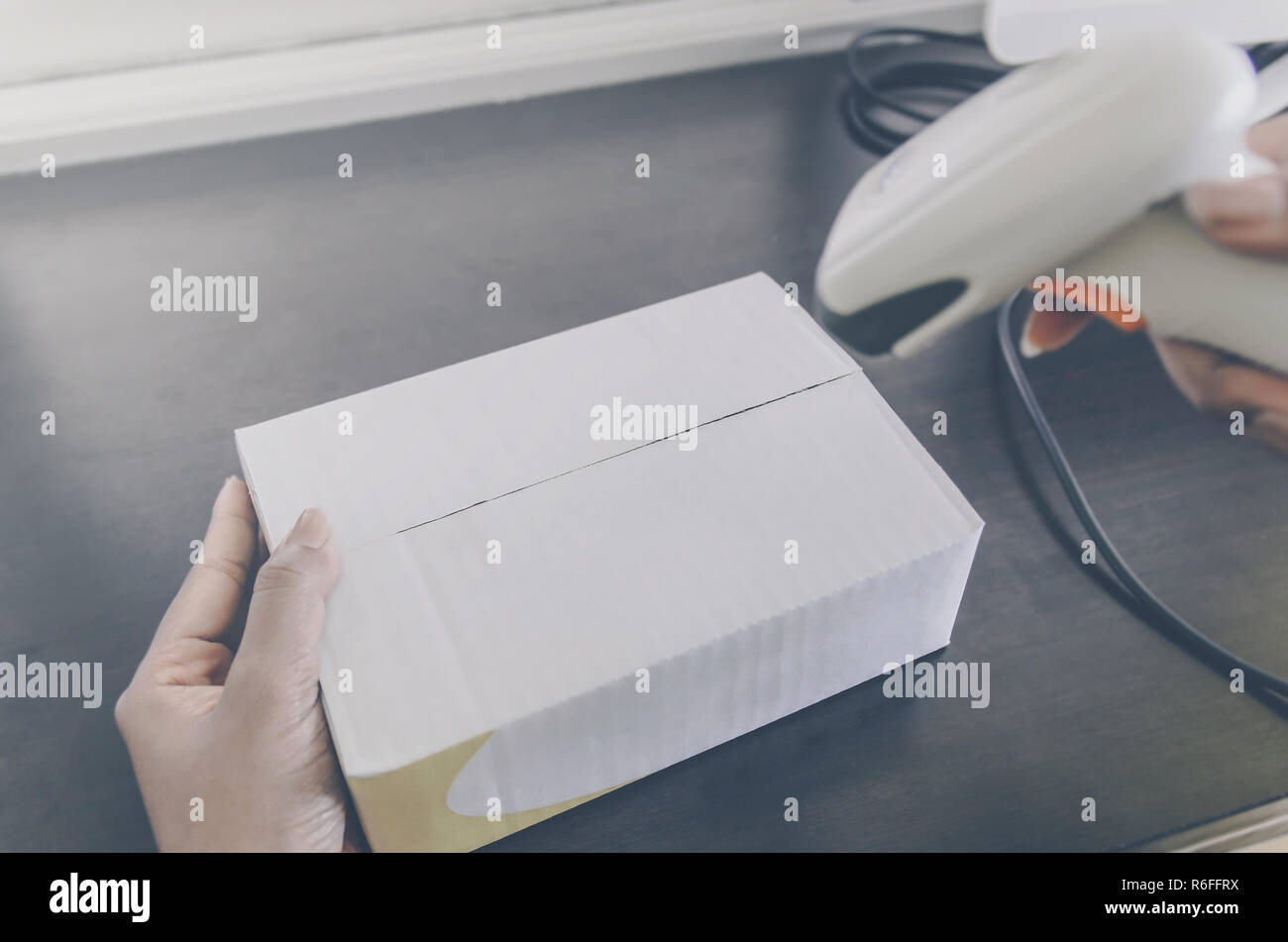 A parcel box and hand holding a package with barcode reader, Delivery ...