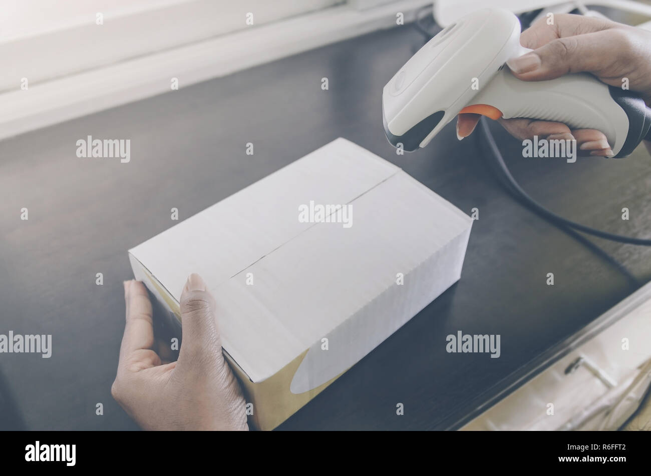 A parcel box and hand holding a package with barcode reader, Delivery ...