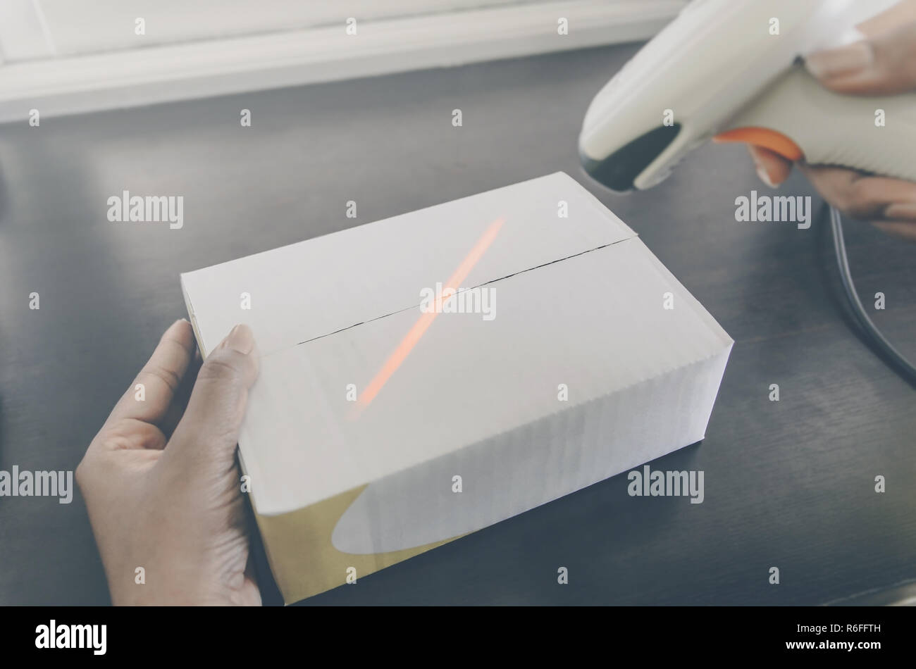 A parcel box and hand holding a package with barcode reader, Delivery ...