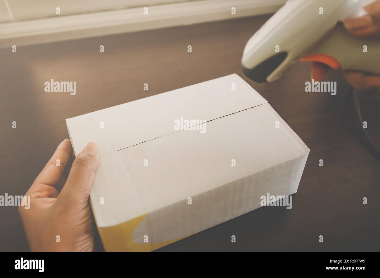 A parcel box and hand holding a package with barcode reader, Delivery ...