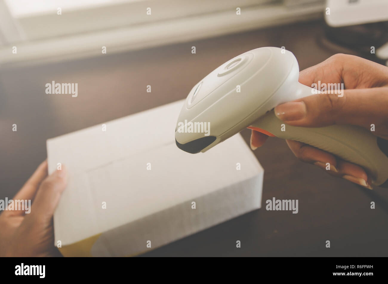 A parcel box and hand holding a package with barcode reader, Delivery ...