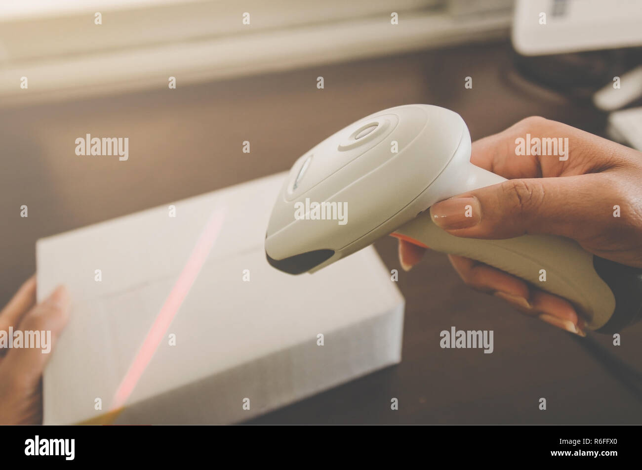 A parcel box and hand holding a package with barcode reader, Delivery ...