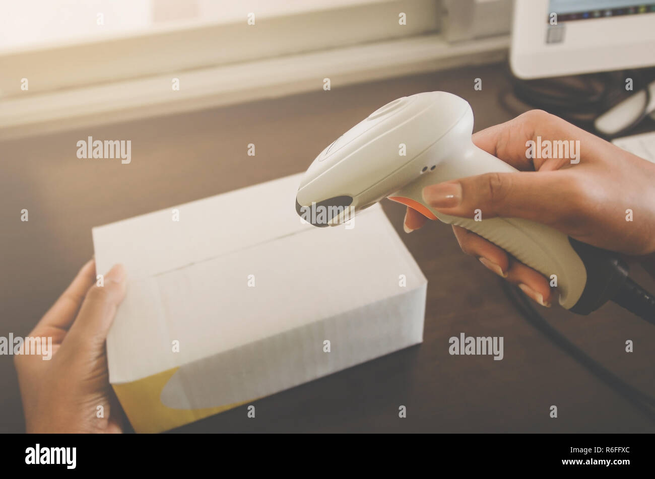 A parcel box and hand holding a package with barcode reader, Delivery ...