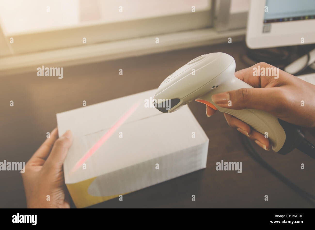 A parcel box and hand holding a package with barcode reader, Delivery ...