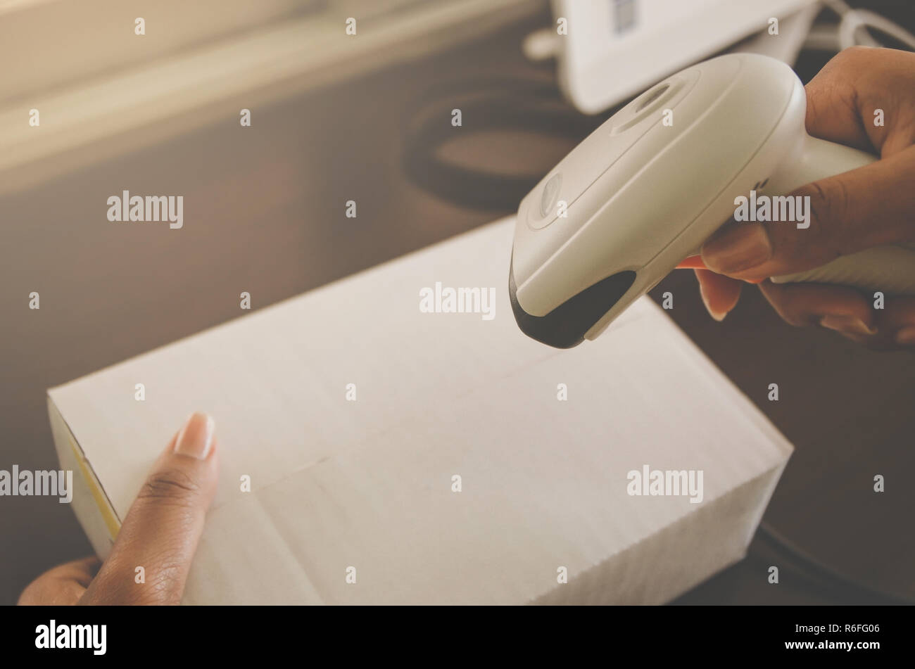 A parcel box and hand holding a package with barcode reader, Delivery ...