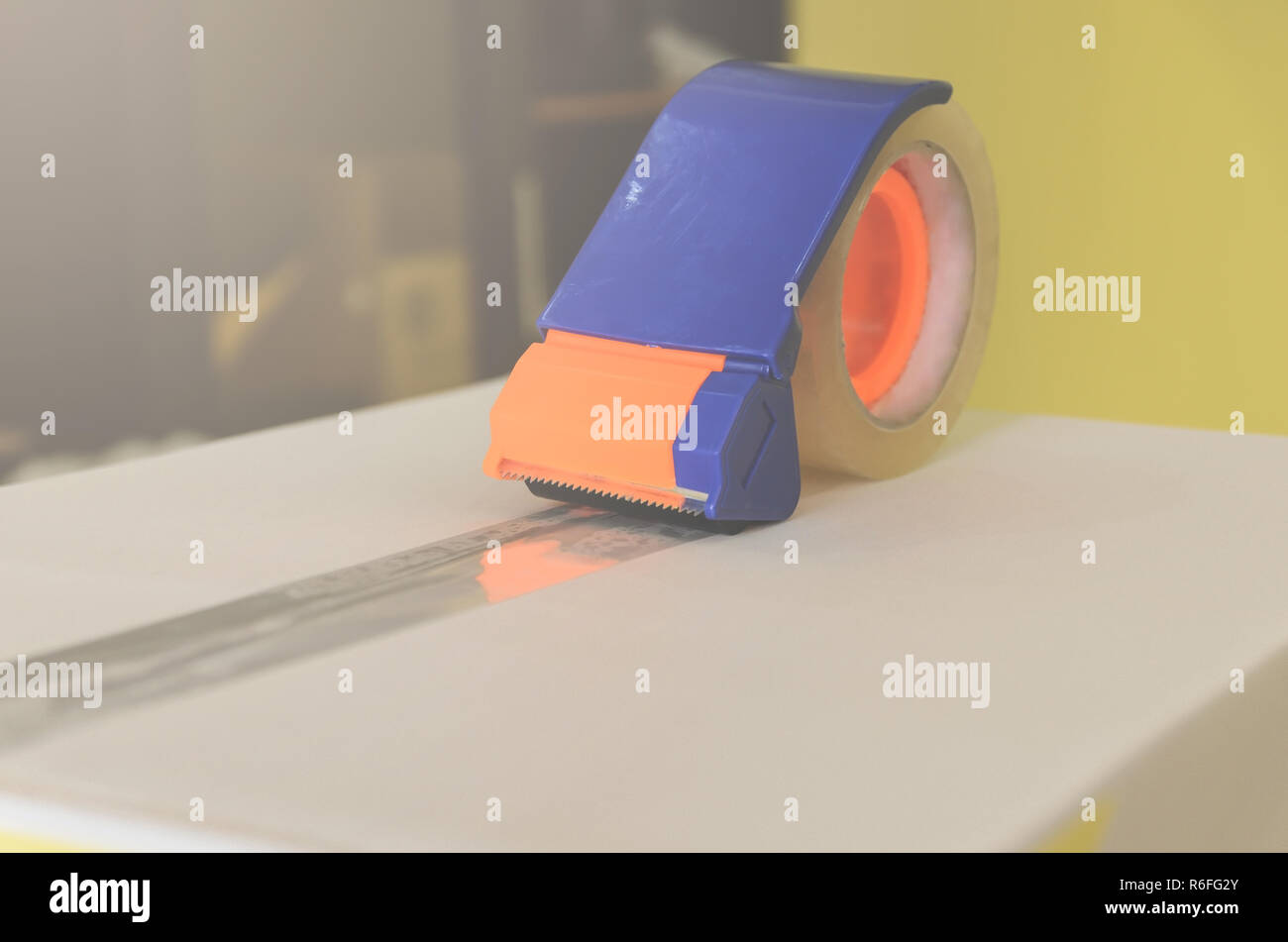 Close - up of parcel box with scissors and scotch tape cutter ...