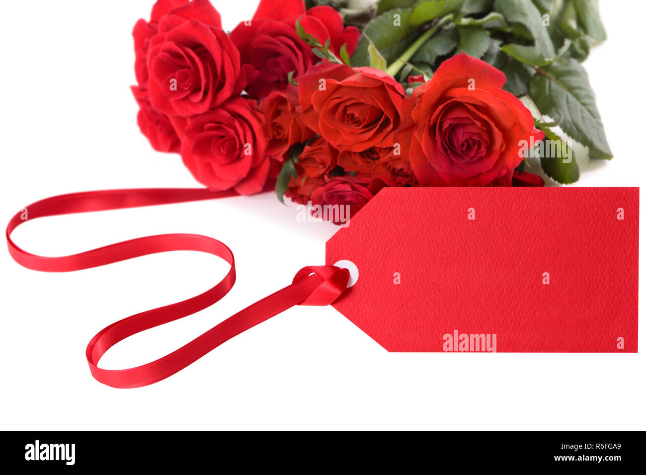 Valentine roses with red gift tag and ribbon Stock Photo - Alamy