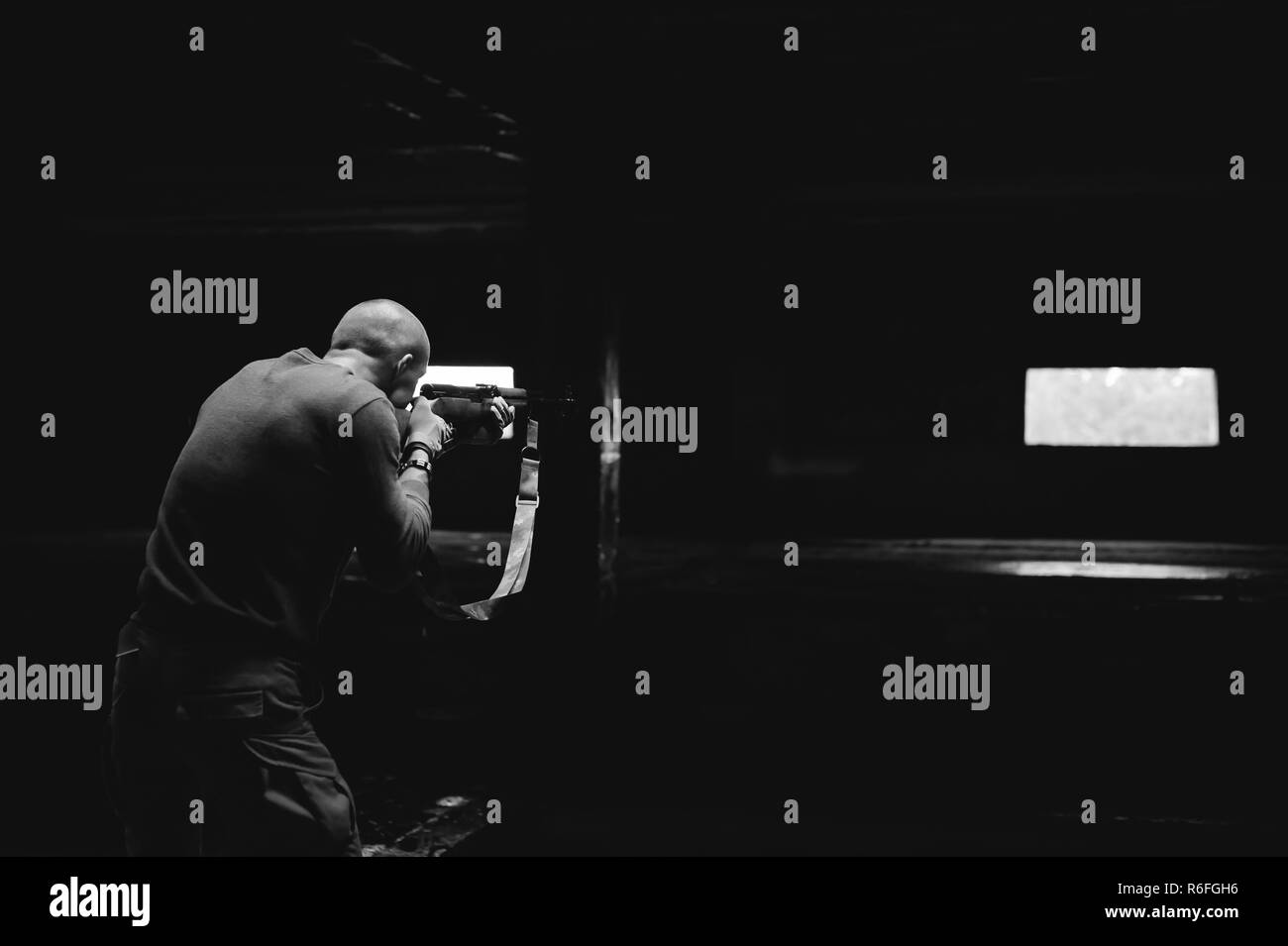 Rear view man aiming gun Black and White Stock Photos & Images - Alamy