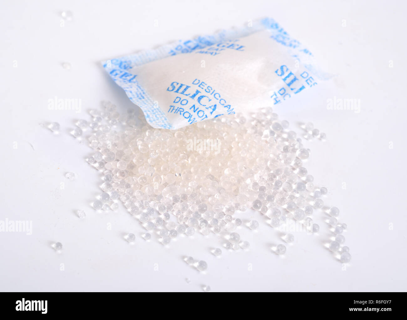 Silicagel pellets and bag on white background Stock Photo - Alamy