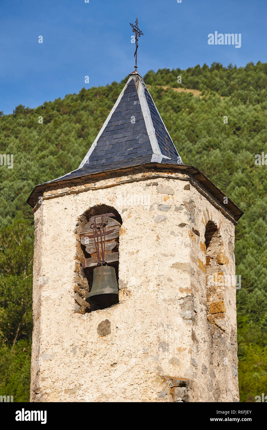Antique stone church bell tower detail with forest background. Vertical ...