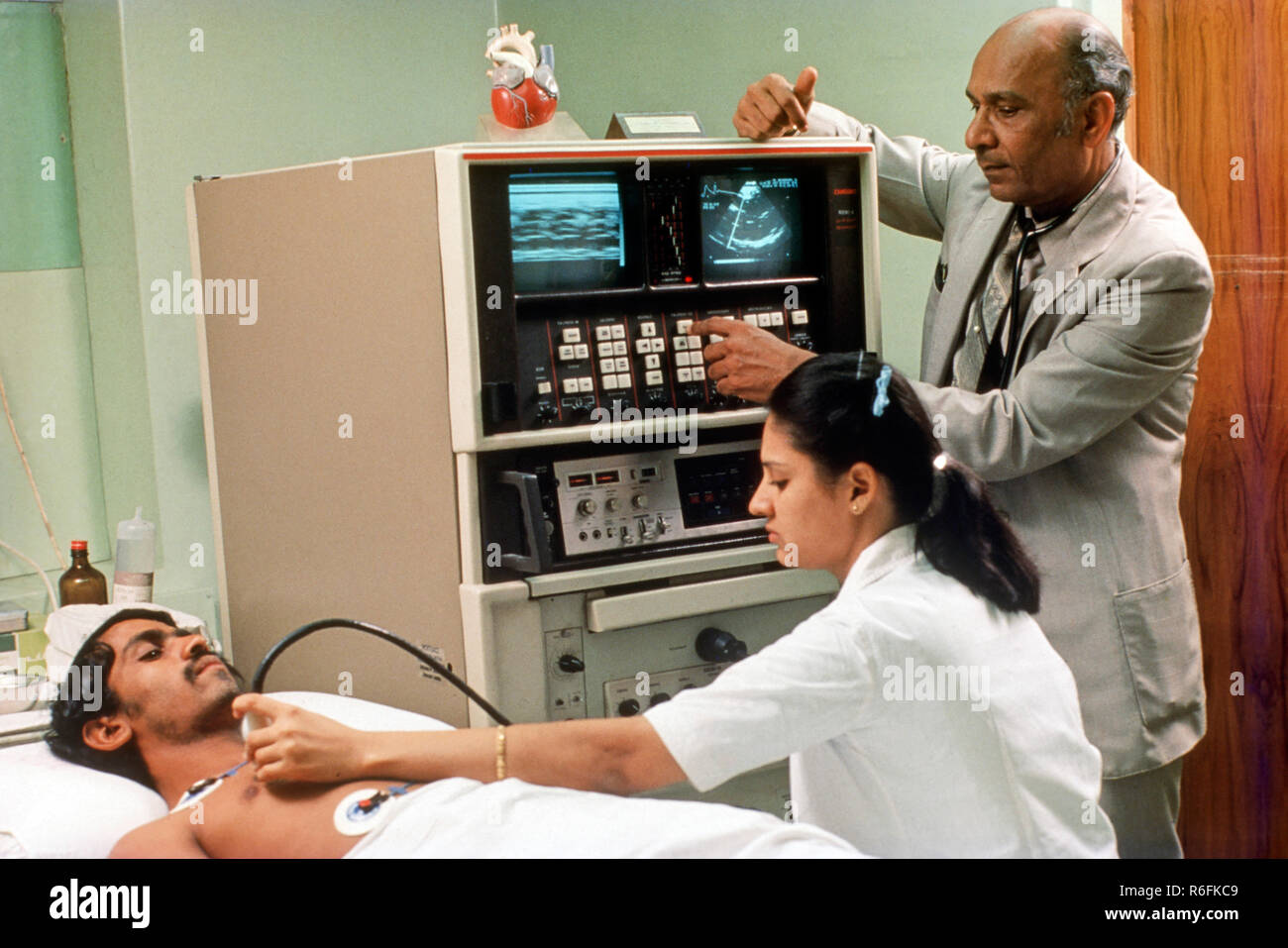 Doctors checking Patient Stock Photo - Alamy