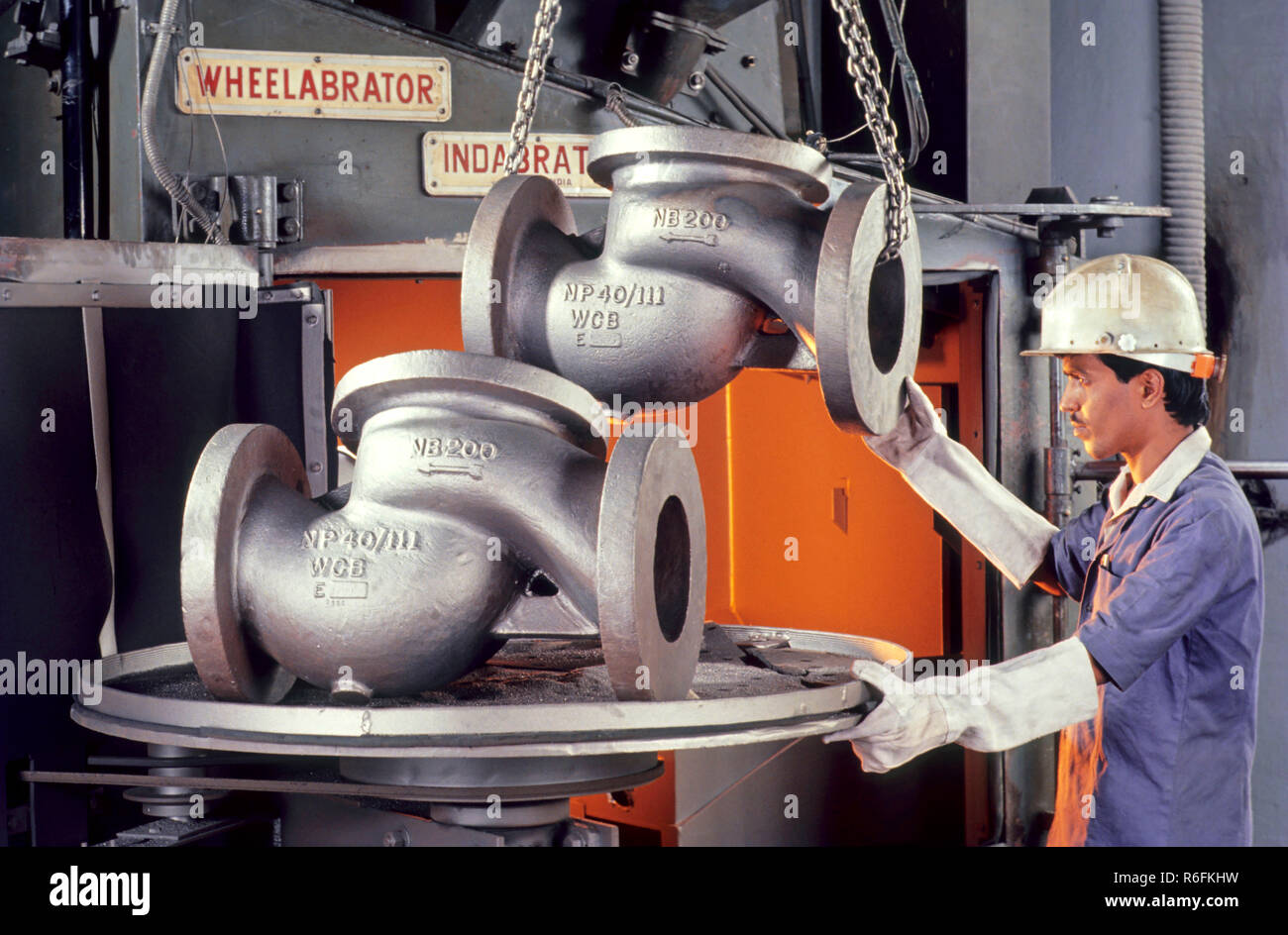 man wearing safety helmet working in valves manufacturing factory Stock ...