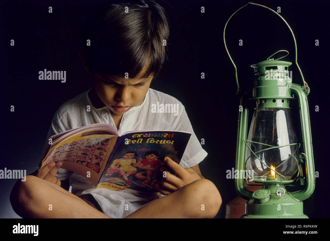 boy reading book in lantern light Stock Photo - Alamy