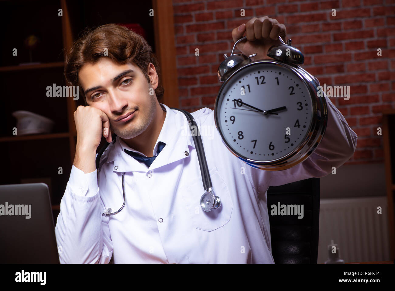 Young handsome doctor working night time at the hospital Stock Photo ...