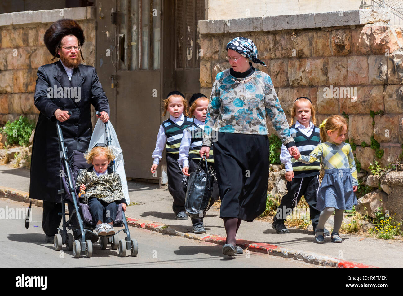 A Traditional Orthodox Judaic Family With The Child On The Mea Shearin ...