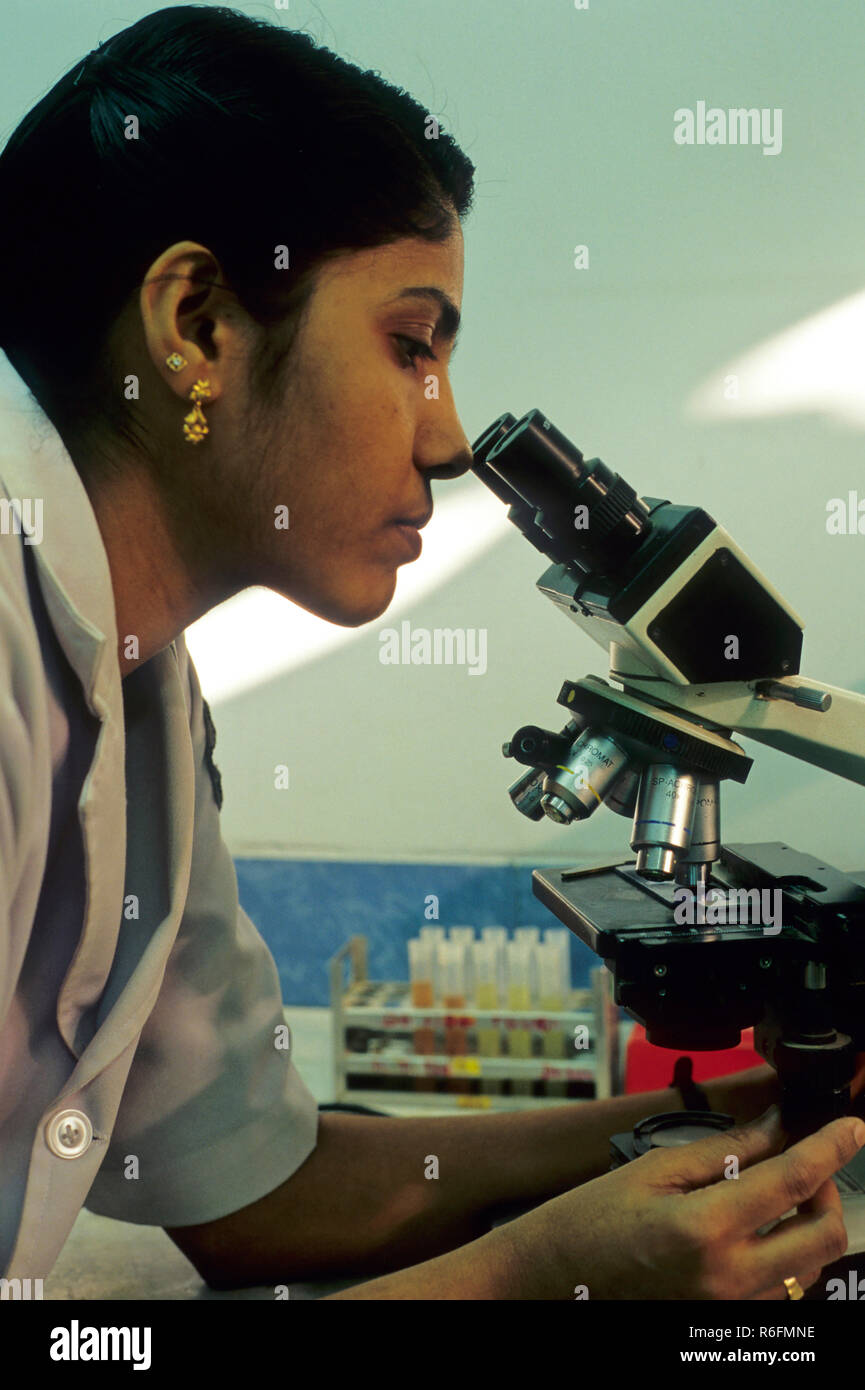 woman Watching Through Microscope in pathology department, jabalpur ...