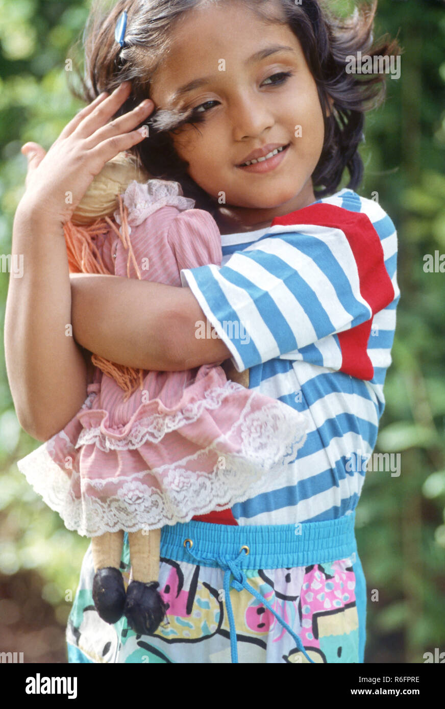 Little Girl Playing With Dolls