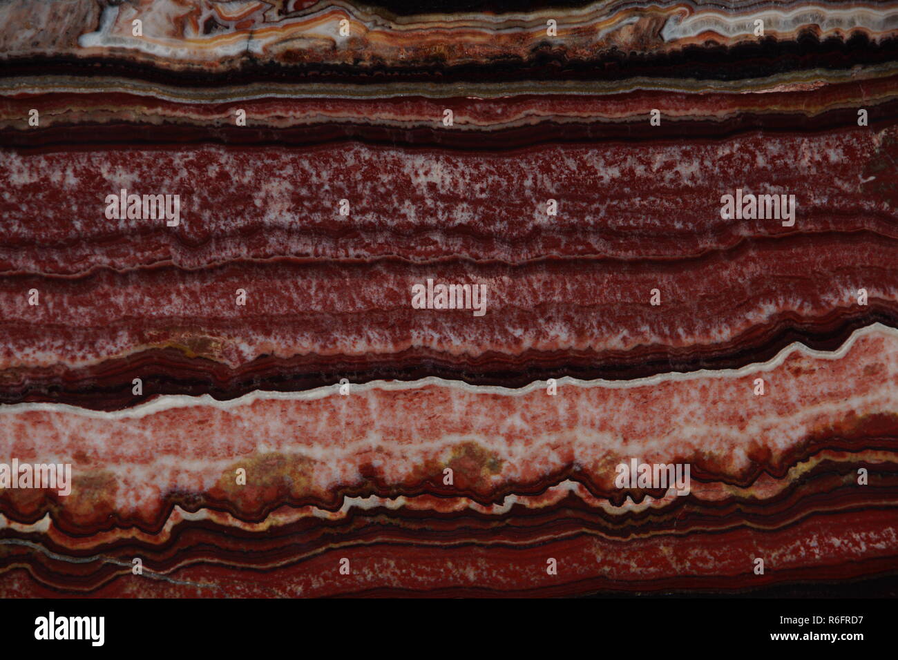 Natural red color Onyx stone with dark and light streaks and a ...