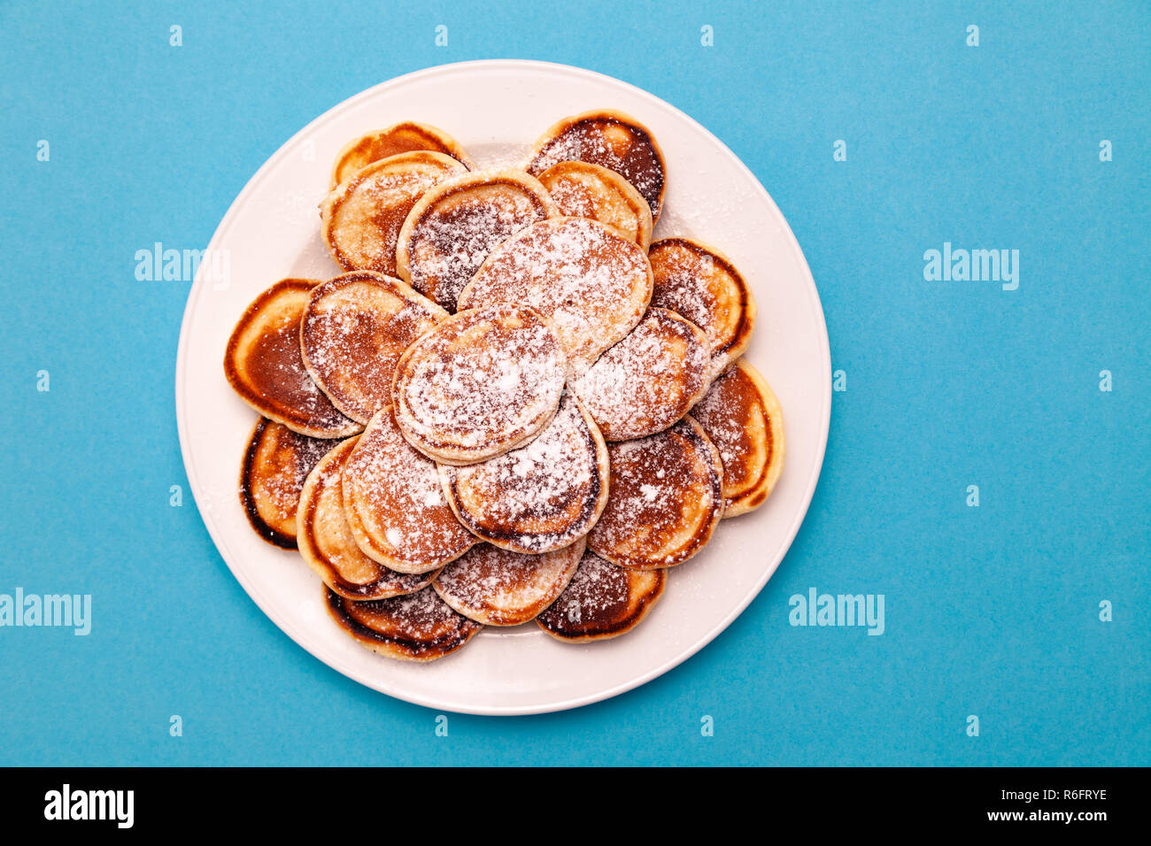 Closeup top view of isolated stack of homemade crispy oval pancakes ...