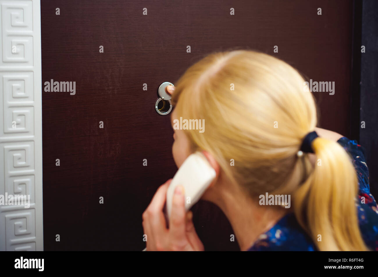 Woman answers door hi-res stock photography and images - Alamy