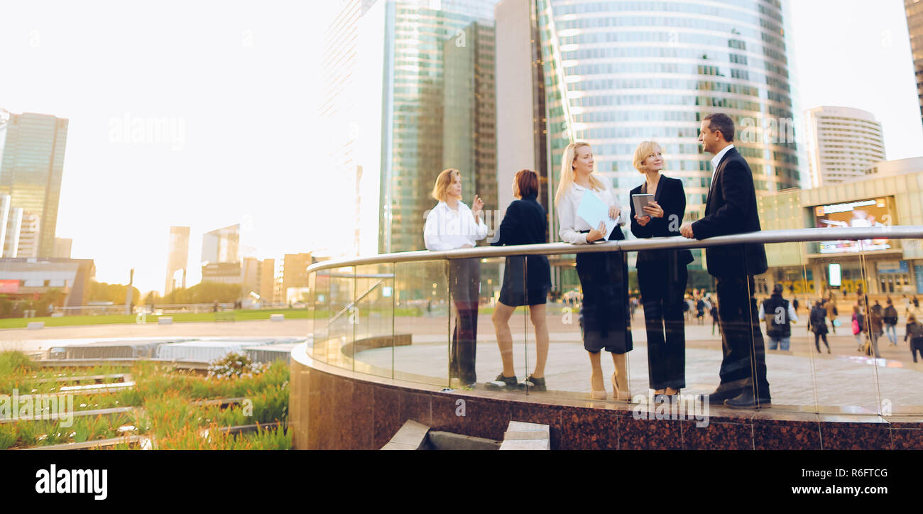 Businesswomen speaking with male boss outside Stock Photo - Alamy