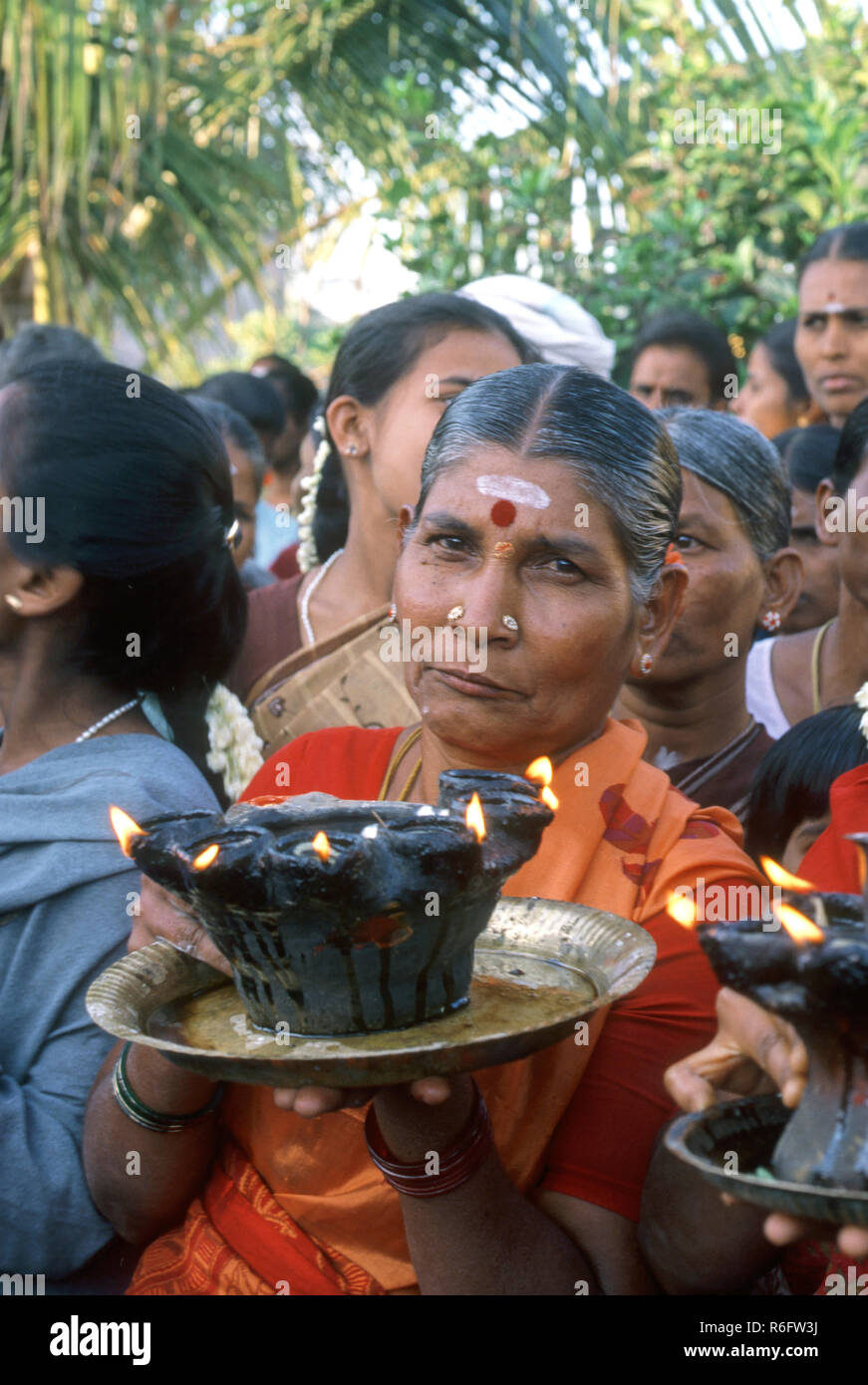 Old woman holding oil lamp on Mahashivaratri festival at Poochiyur ...