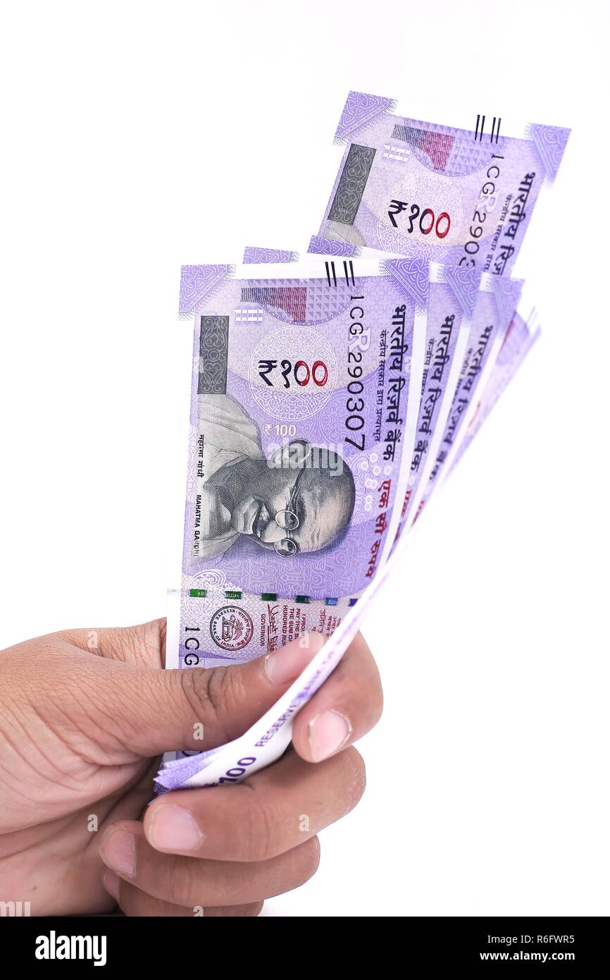 Hand with new Indian currency notes. Isolated on the white background ...