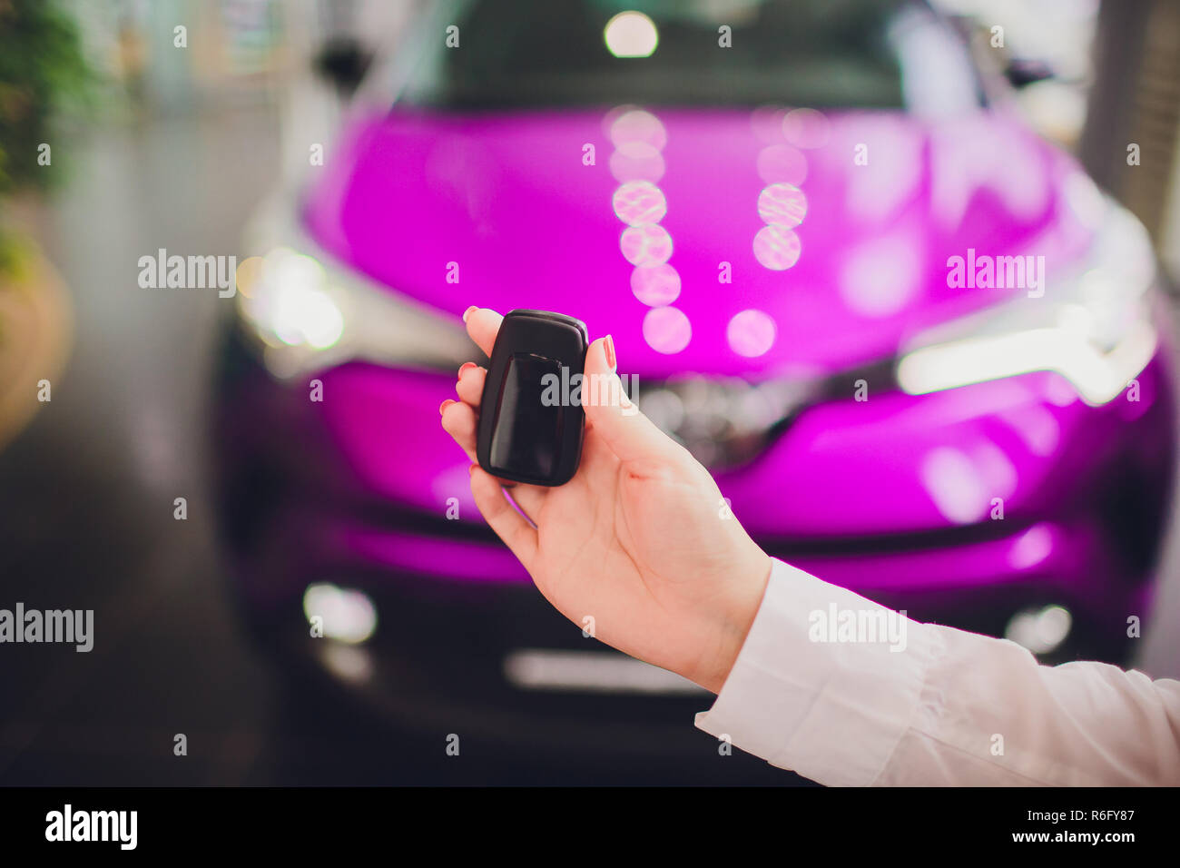 Female holding car keys with car on background pink color Stock Photo ...