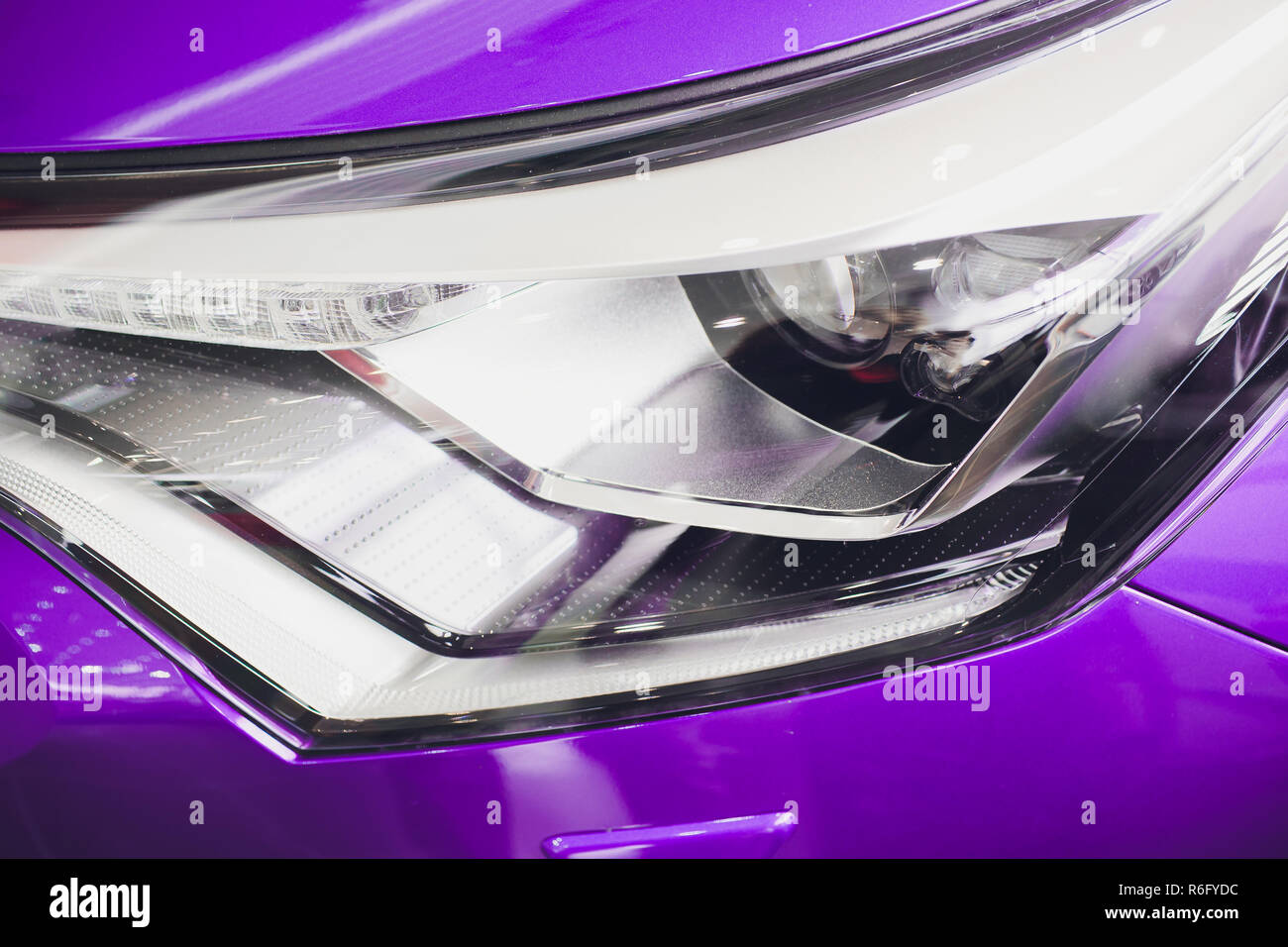 Close up shot headlight in luxury purple car background. Modern and ...