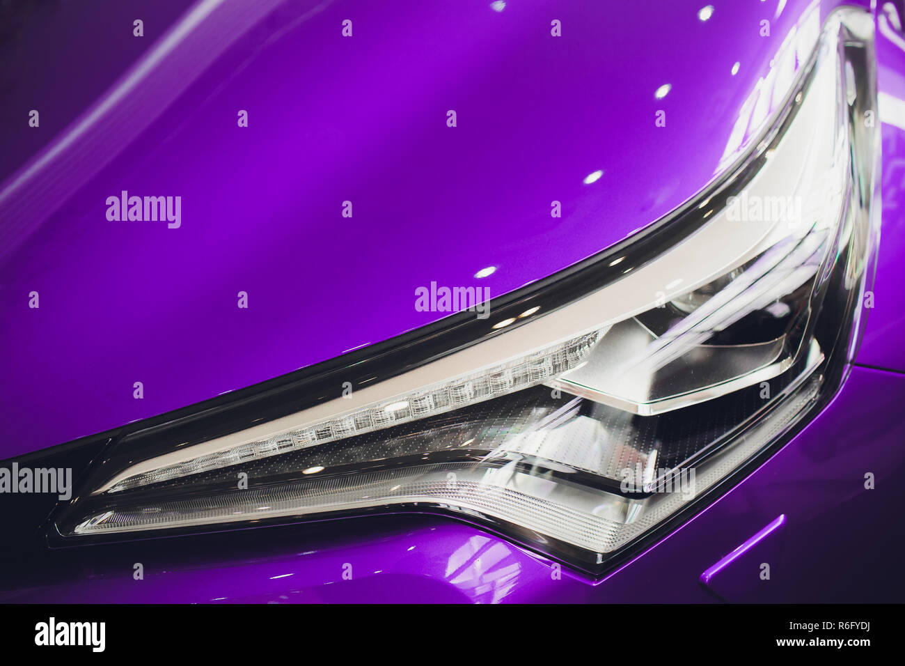 Close up shot headlight in luxury purple car background. Modern and ...