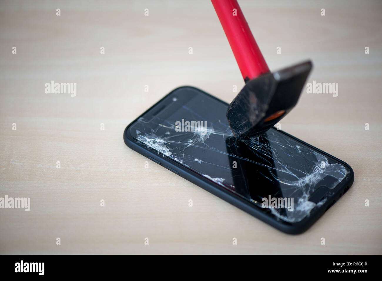 Hammer cracking on smartphone. Screen and display is destroyed, damaged ...