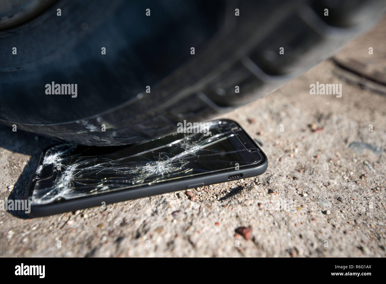 Broken and damaged smartphone with cracks on glass screen laying on ...