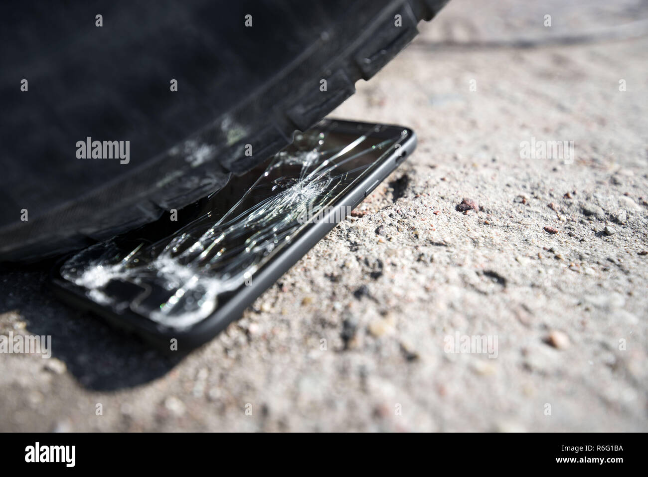 Broken and damaged smartphone with cracks on glass screen laying on ...