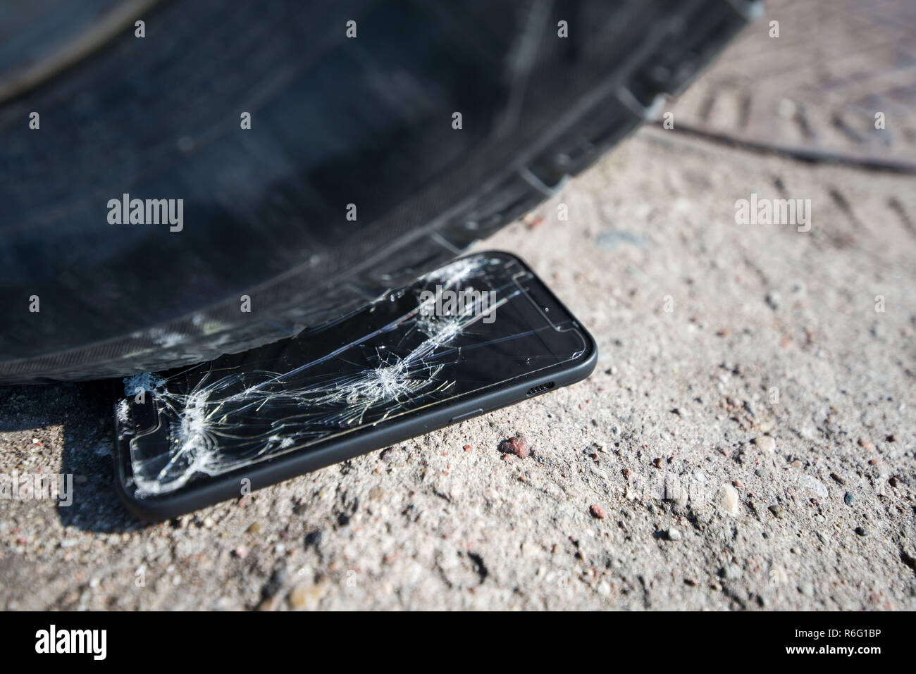 Broken and damaged smartphone with cracks on glass screen laying on ...