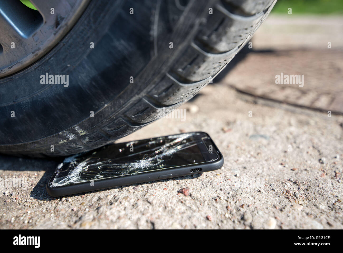 Broken and damaged smartphone with cracks on glass screen laying on ...