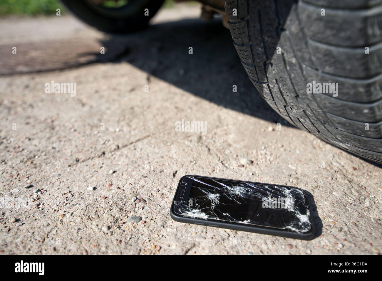 Broken and damaged smartphone with cracks on glass screen laying on ...