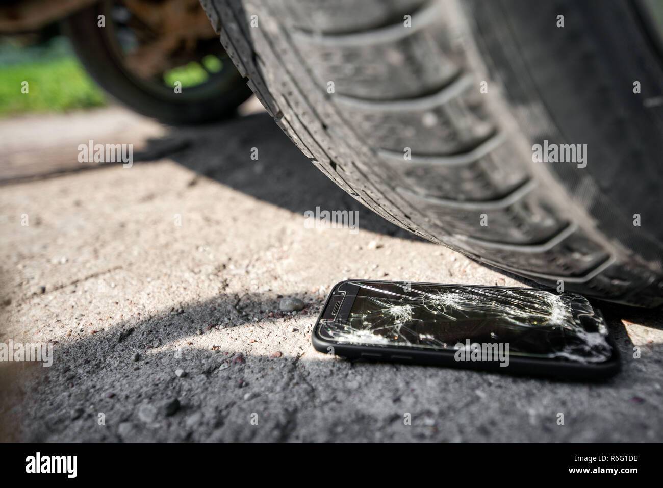Broken and damaged smartphone with cracks on glass screen laying on ...