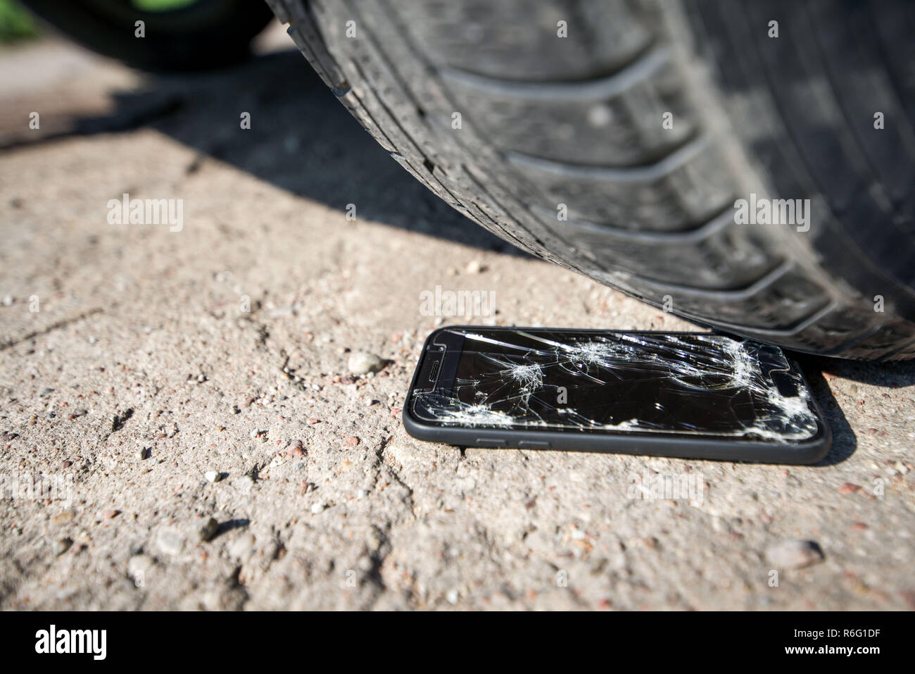 Broken and damaged smartphone with cracks on glass screen laying on ...