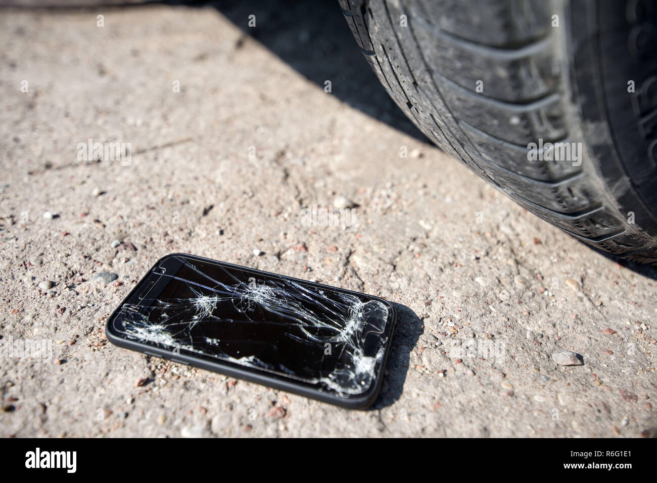 Broken and damaged smartphone with cracks on glass screen laying on ...