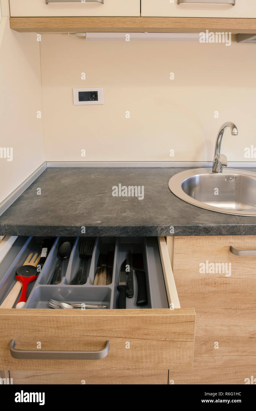 open drawers with cutlery in the kitchen Stock Photo - Alamy