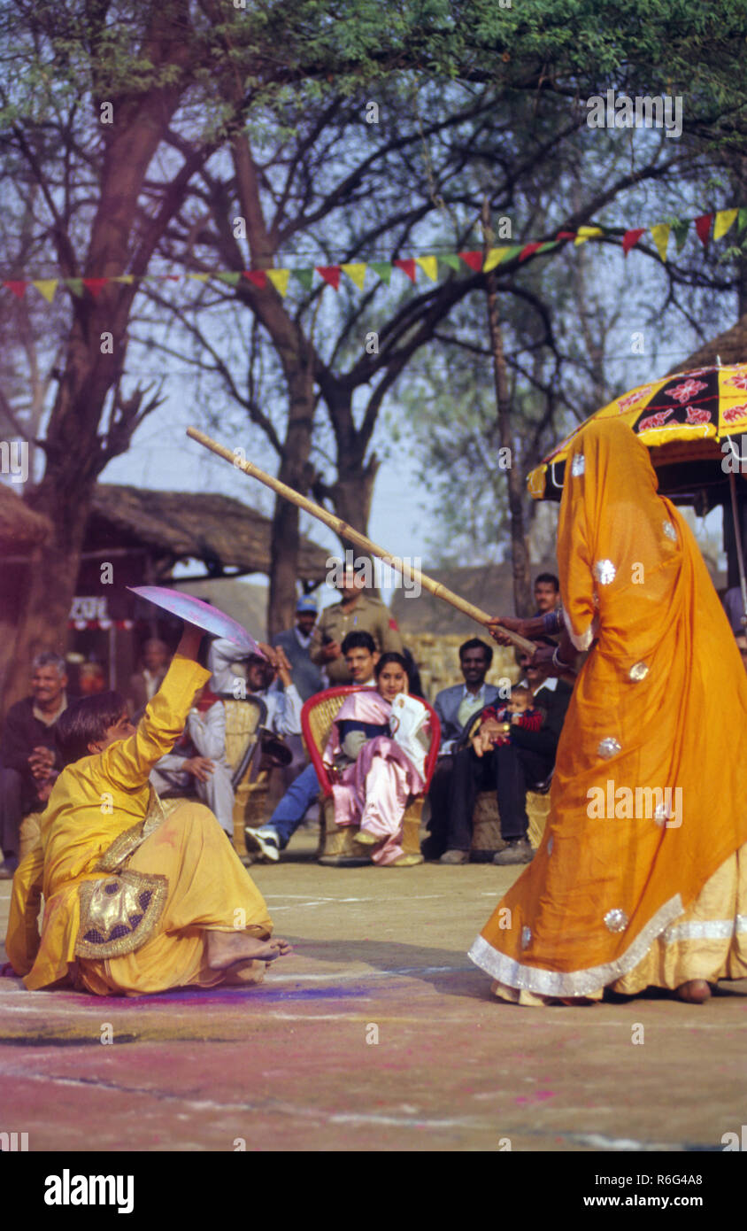 woman attacking man defending shield, Surajkund Fair, Faridabad ...