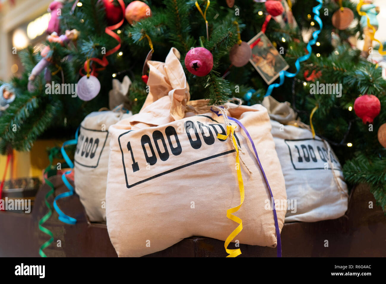 Money bags under the Christmas tree Stock Photo - Alamy