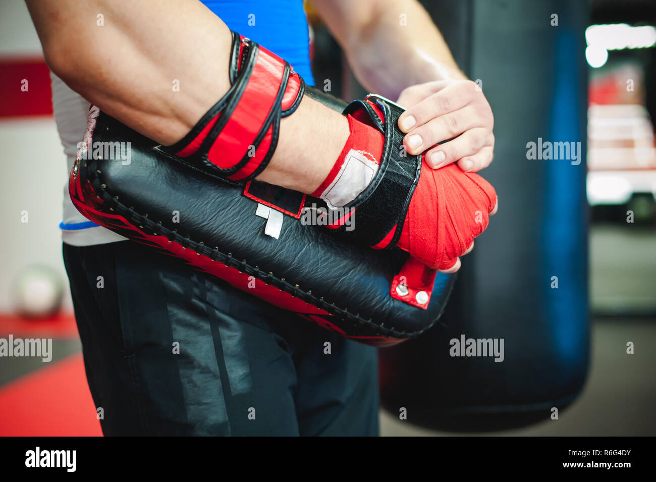 Professional fighter coach puts on boxing paws Stock Photo - Alamy